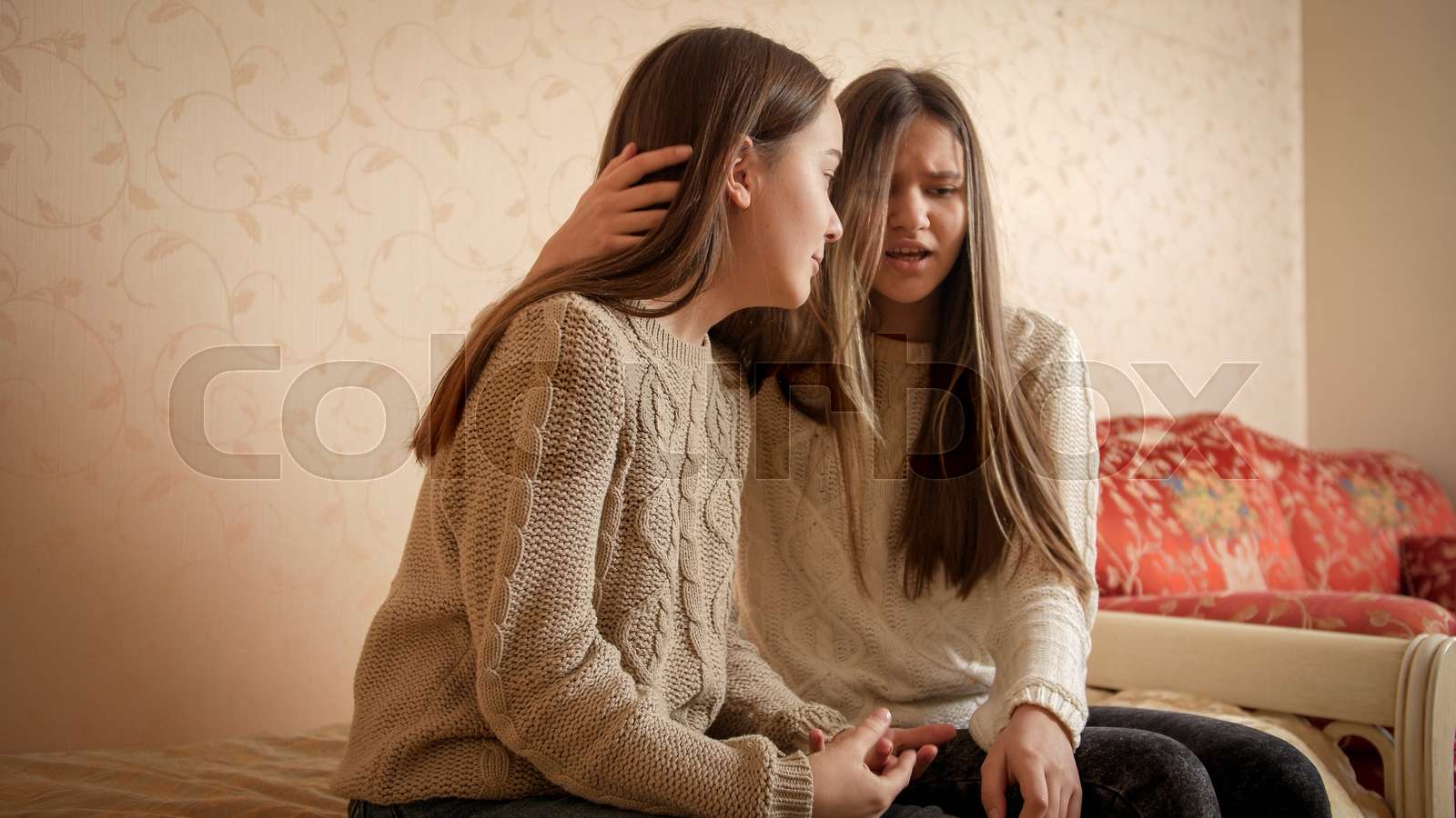 Teenage girl consoling and comforting her friend talking about her ...