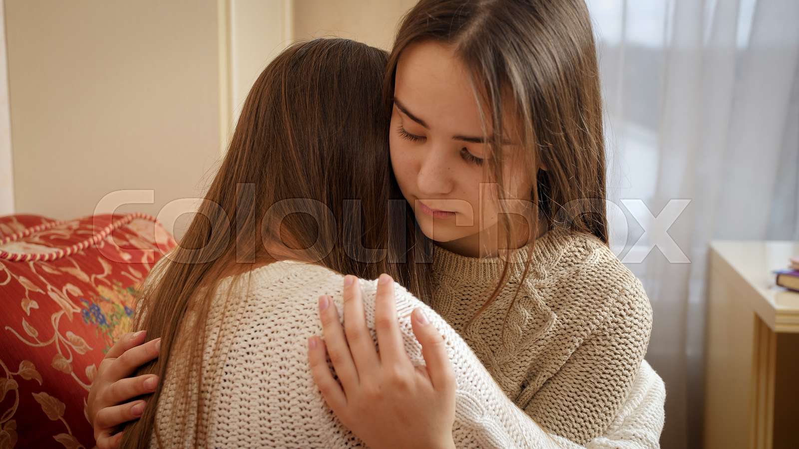 Upset teenage girl crying at her friends shoulder. Friends support and ...