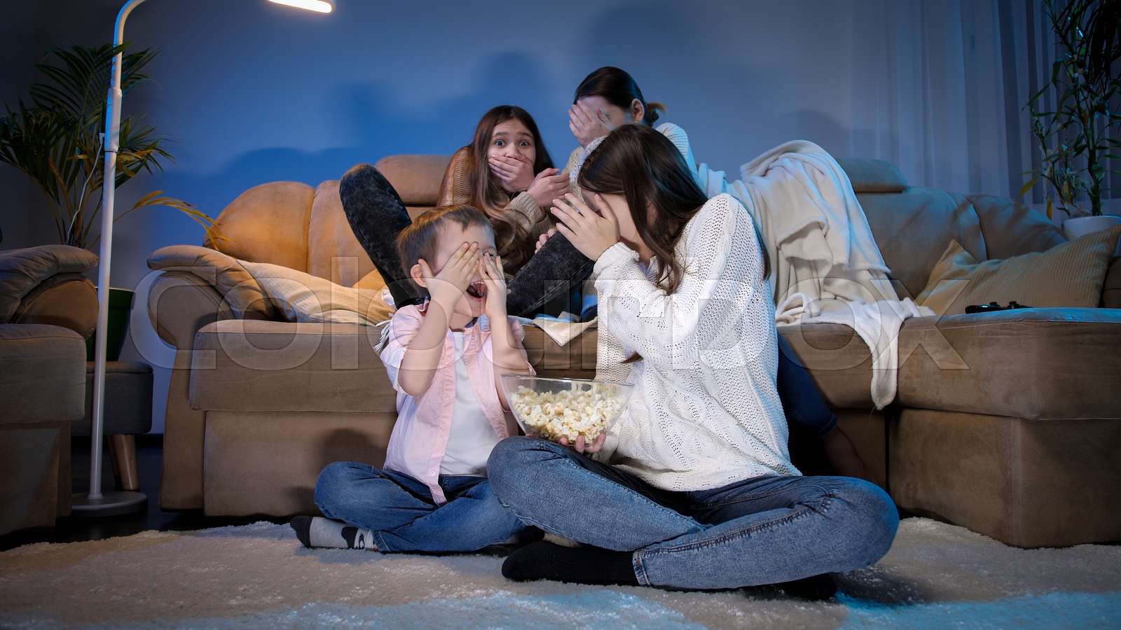 Big family got scared while watching scary horror movie or TV show at ...