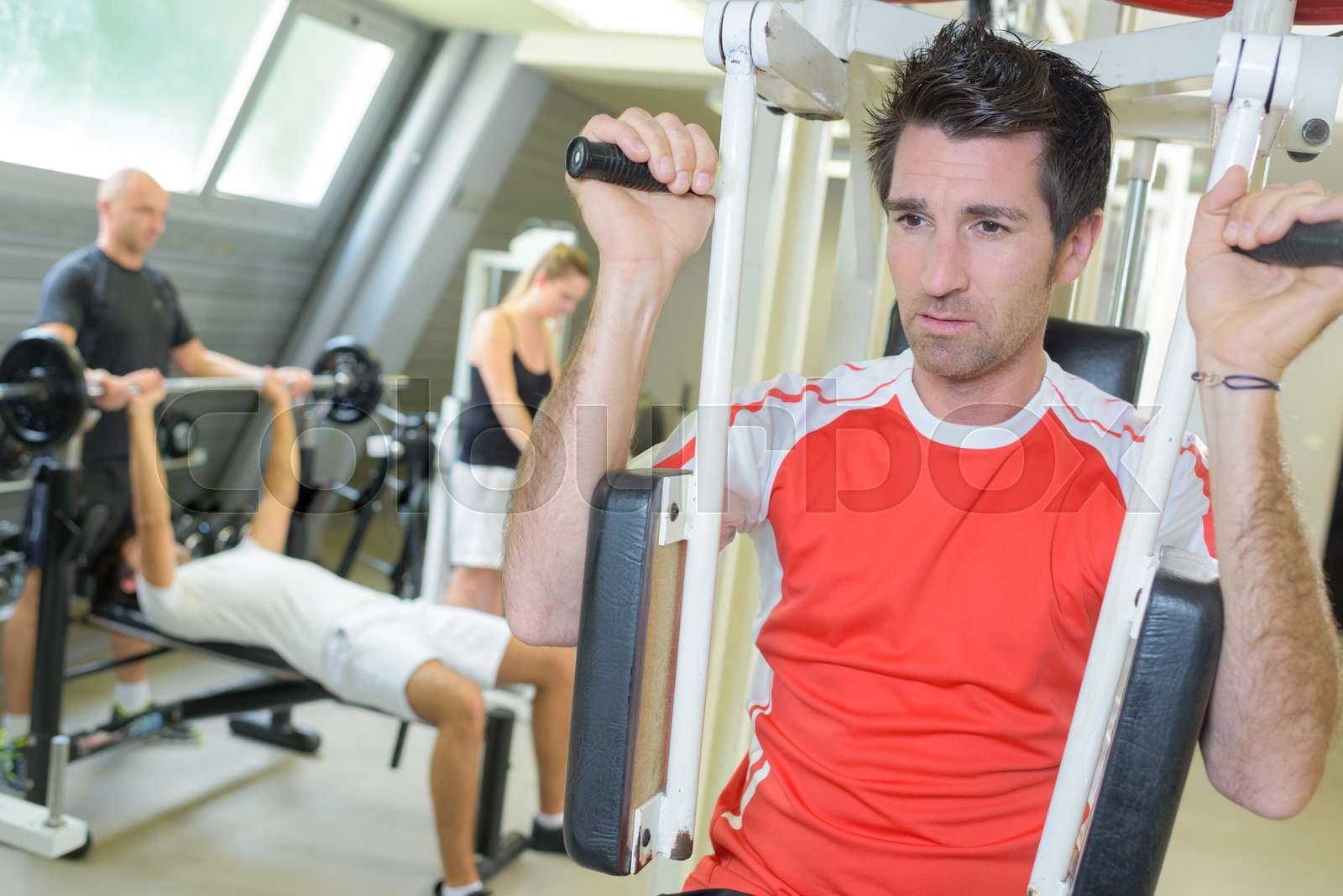 Men working out using gym equipment | Stock image | Colourbox
