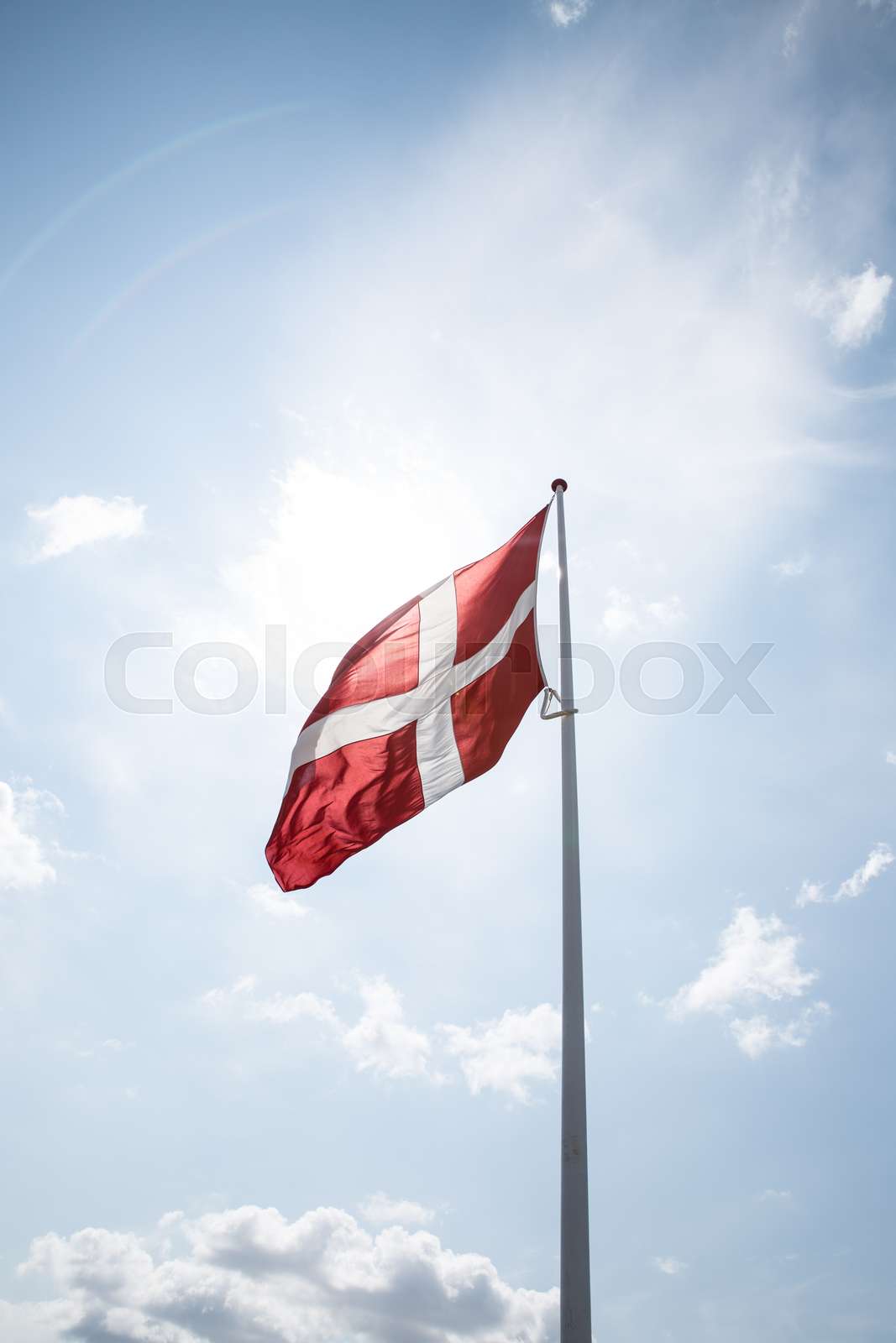 Dansk dannebrog flag på blå himmel | Stock foto | Colourbox