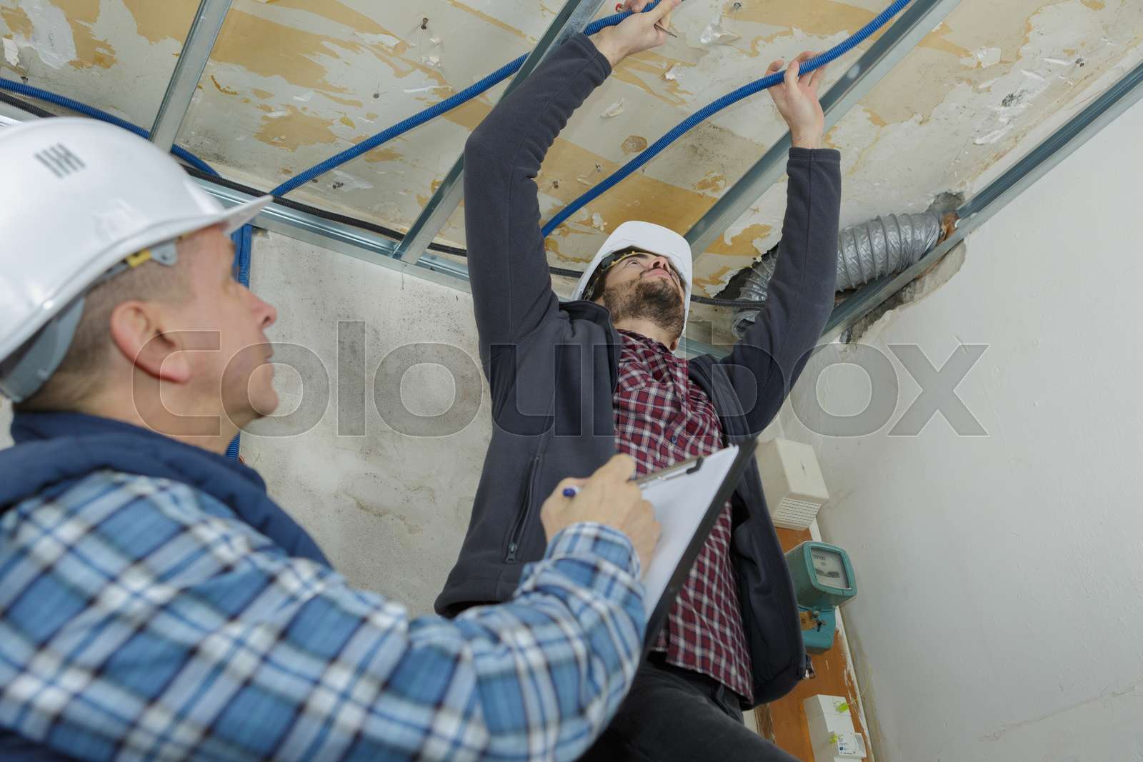 builders putting or repairing up a suspended ceiling | Stock image ...