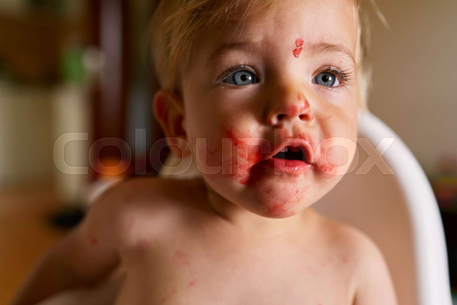Child with a messy face opens his mouth. Close-up | Stock image | Colourbox
