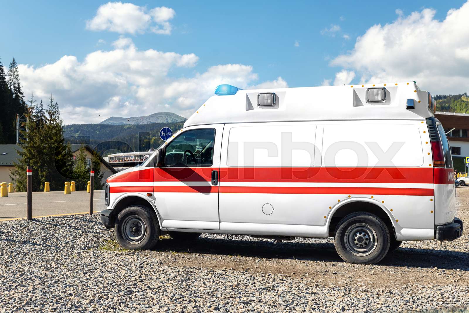Side view of white ambulance rescue ems van car parked near countryside ...