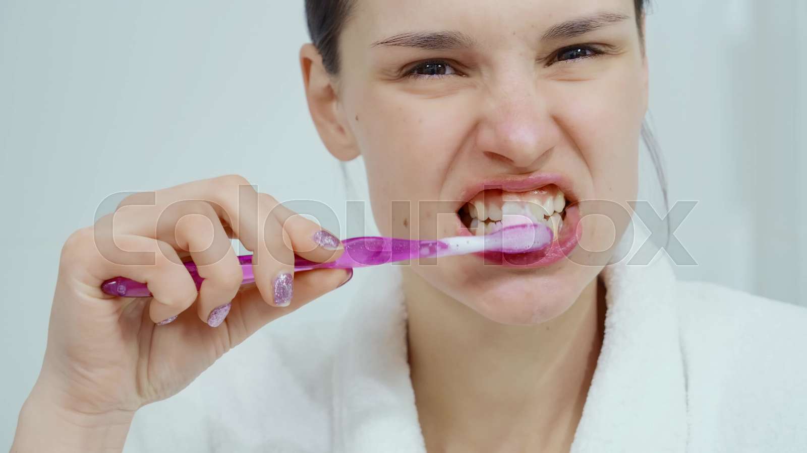 Smiling woman washing her teeth in front of mirror. | Stock video ...