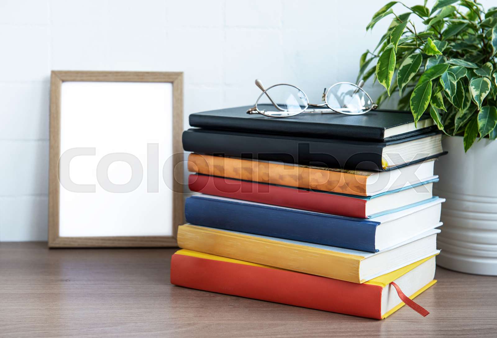 Stack of books on the desktop. | Stock image | Colourbox
