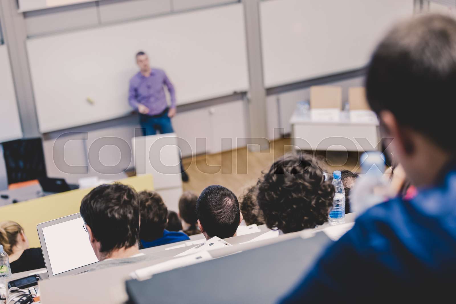 Professor giving presentation in lecture hall at university. | Stock ...