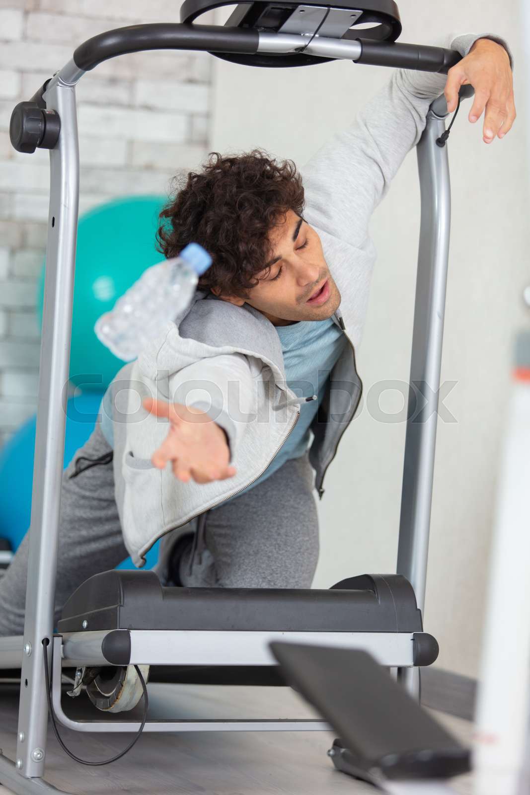 man falling on a treadmill while during gym | Stock image | Colourbox