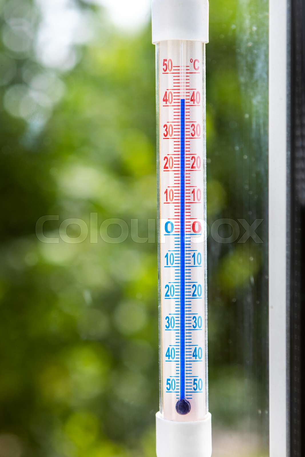 A Celsius thermometer on a window frame shows high temperatures of 42 ...