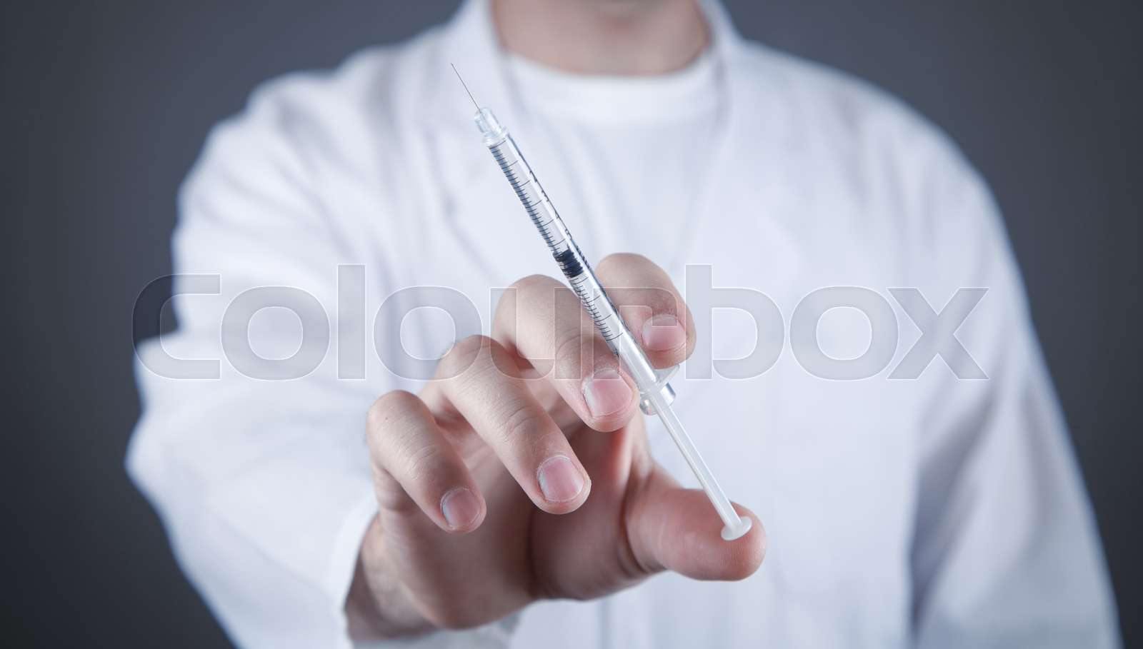 Doctor holding syringe. Healthcare and medical | Stock image | Colourbox