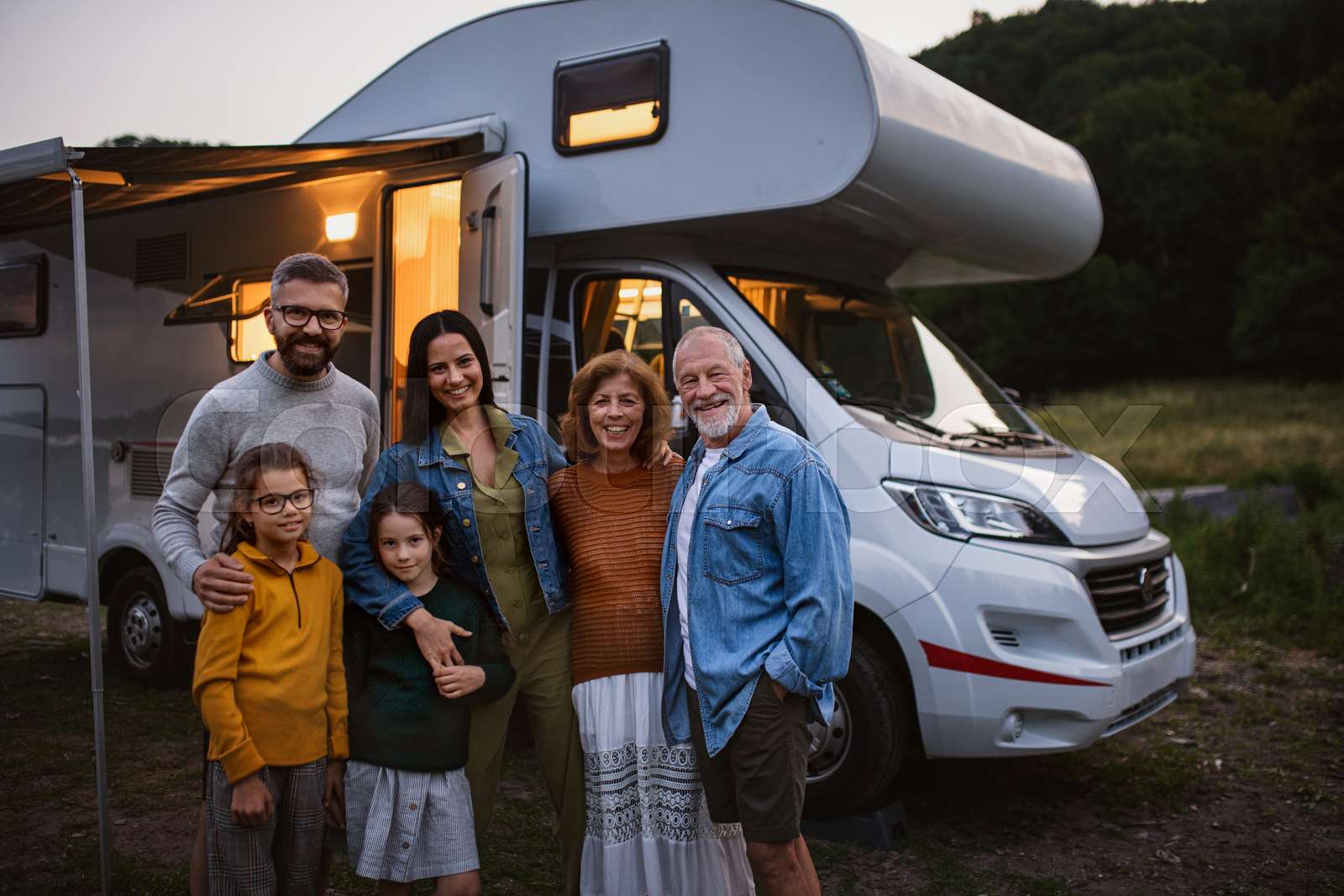 Portrait of multi-generation family looking at camera and smiling ...