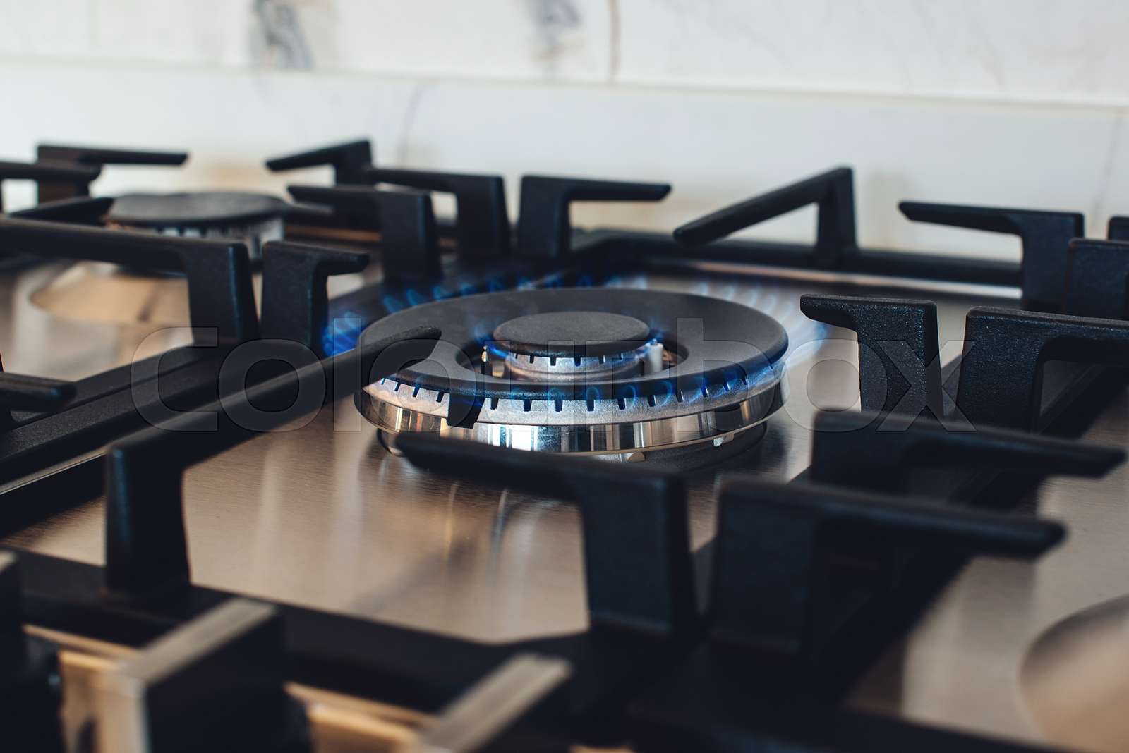 Blue fire from domestic kitchen stove top. Gas cooker with burning ...