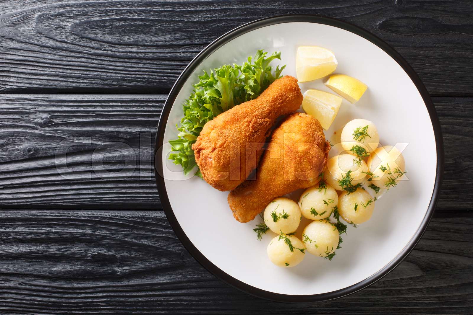 Austrian Fried Chicken Backhendl served with lemon and new potatoes ...