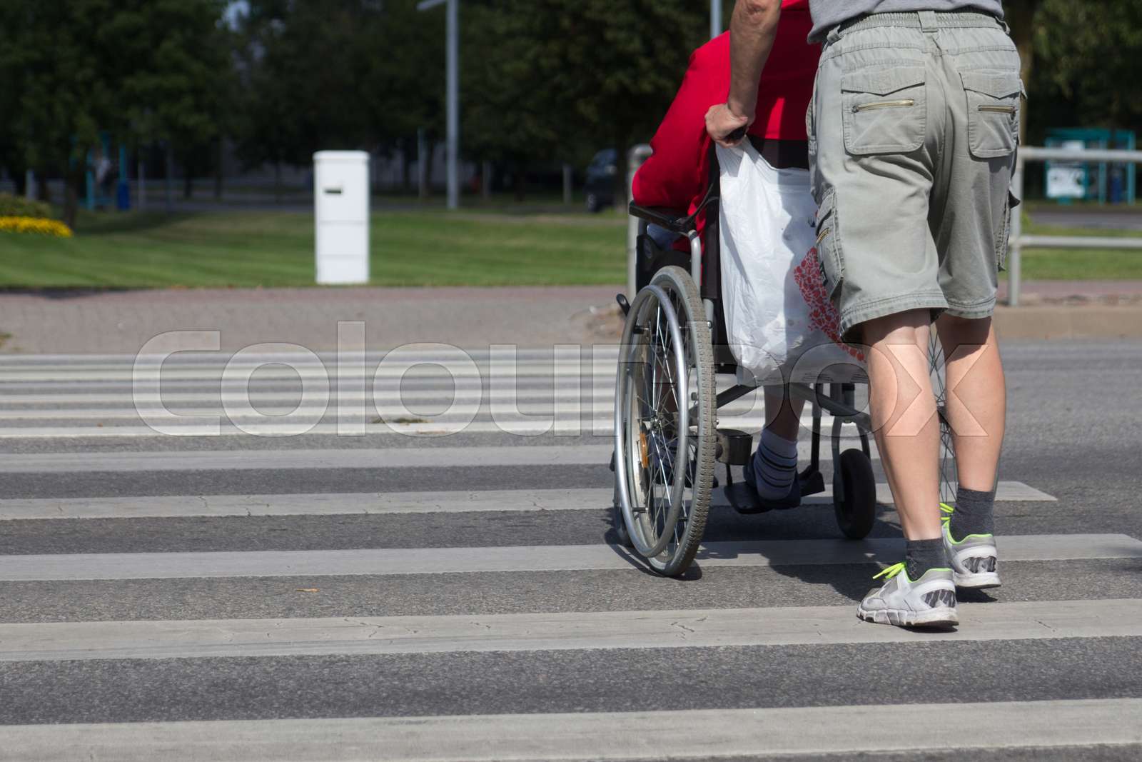 A man pushes wheelchair with disabled | Stock image | Colourbox