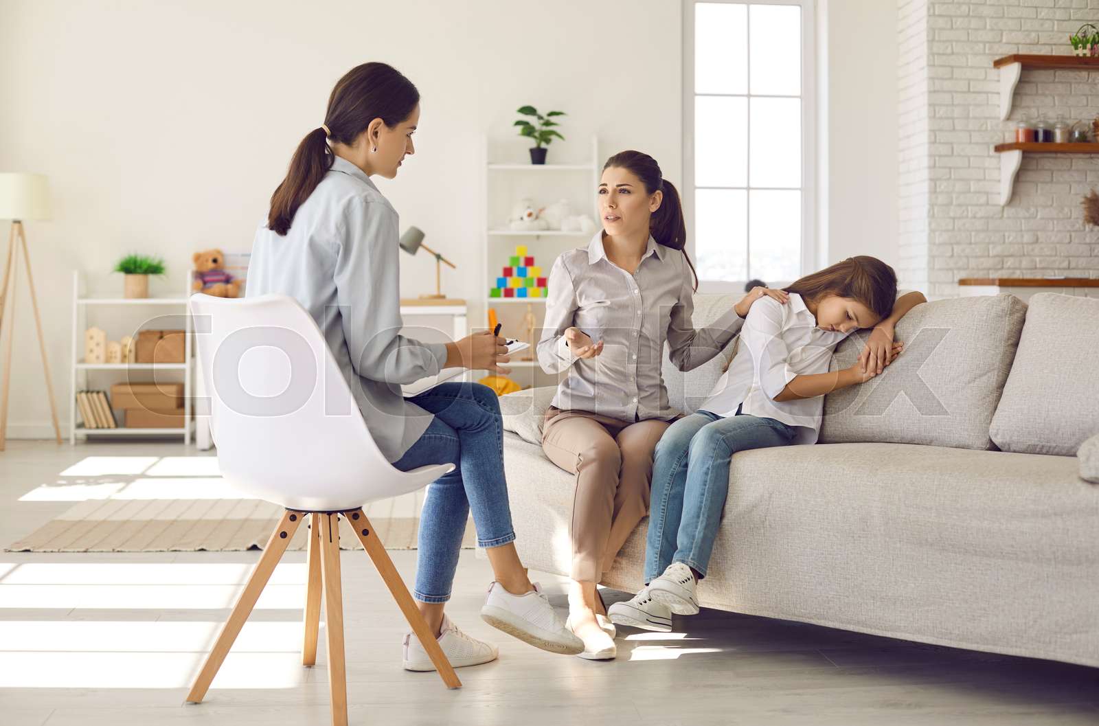 Worried parent having conversation with psychologist about child's ...