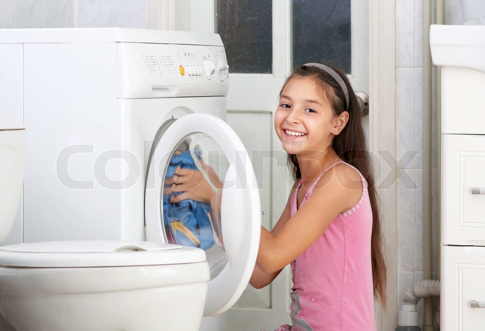 The girl is washing clothes | Stock image | Colourbox