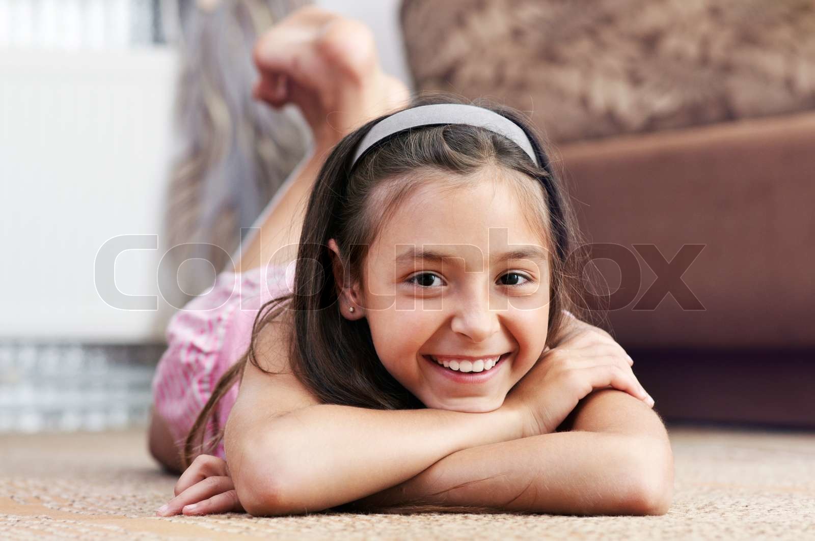 The girl is lying the carpet | Stock image | Colourbox