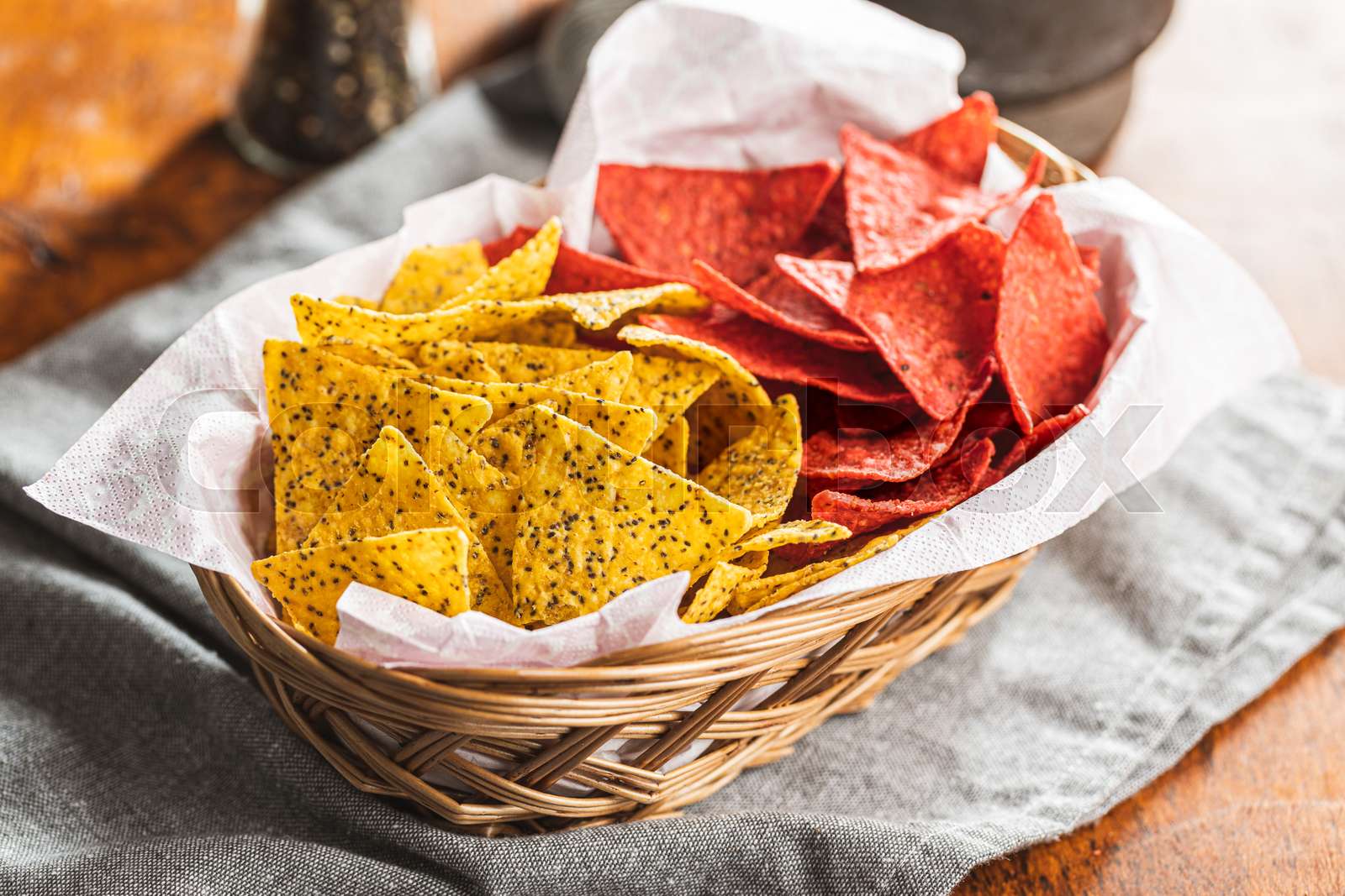 Salted tortilla chips triangle with red beet flavor and with chia seeds ...