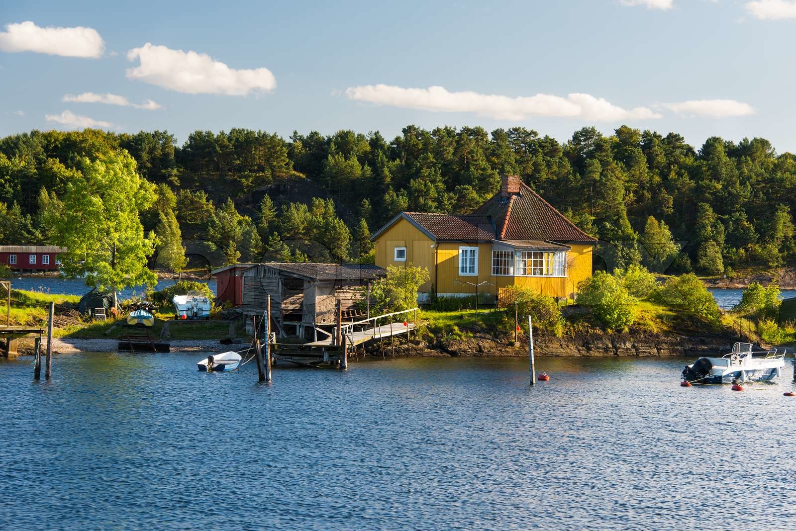 Yellow house near water | Stock image | Colourbox