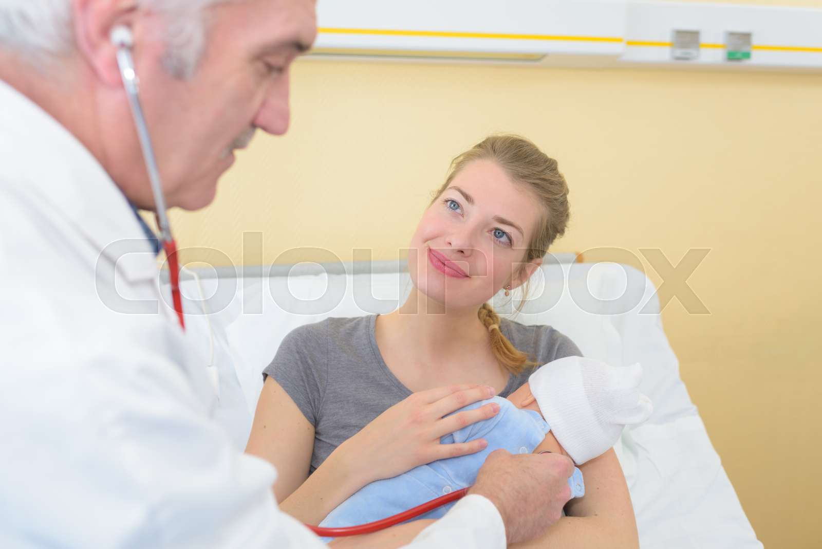 pediatrician doctor talks to young mother of newborn baby | Stock image ...
