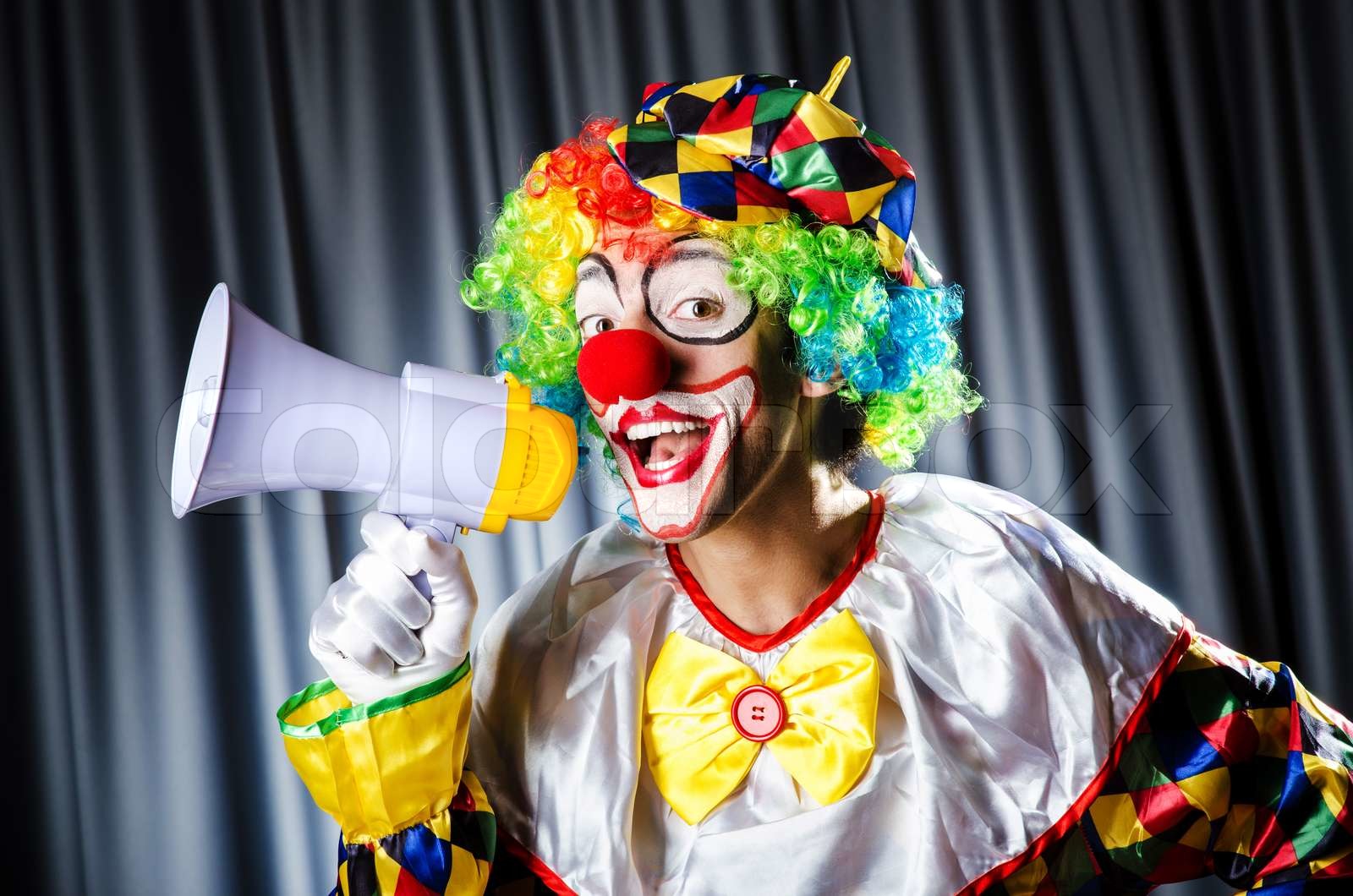Clown in studio with loudspeaker | Stock image | Colourbox