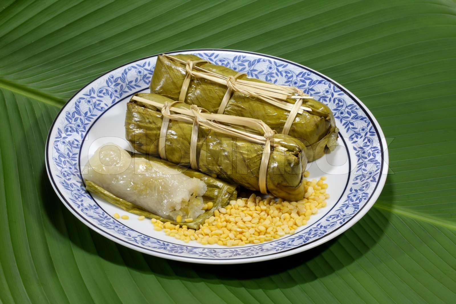 Rice and beans steamed in banana leaf | Stock image | Colourbox