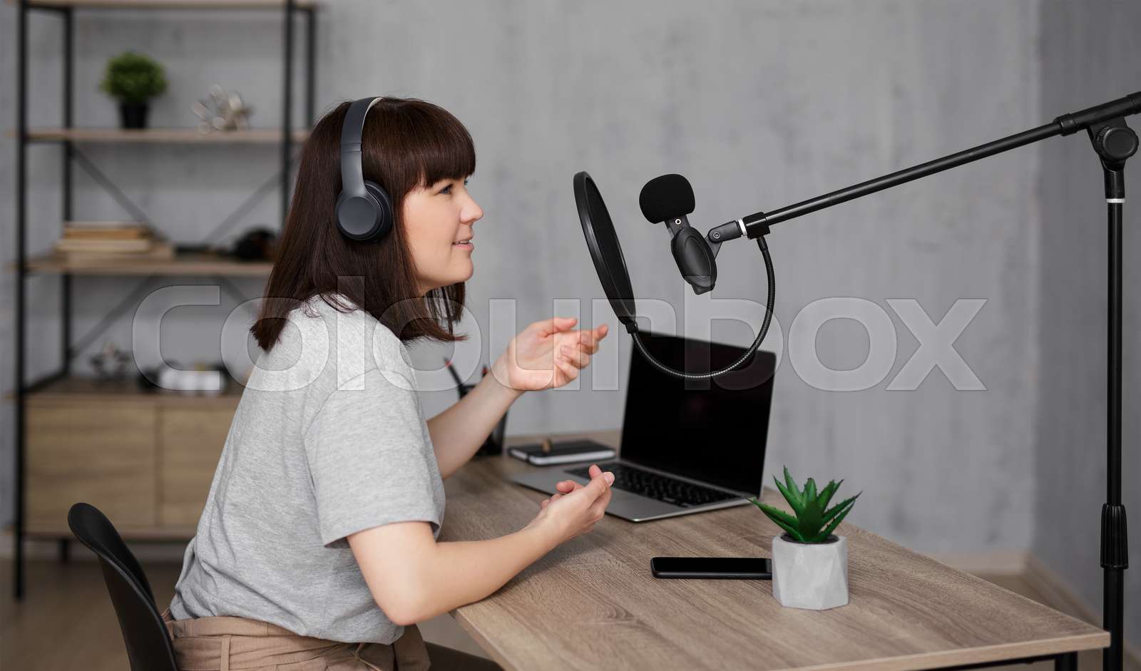 young woman recording audio podcast in studio | Stock image | Colourbox