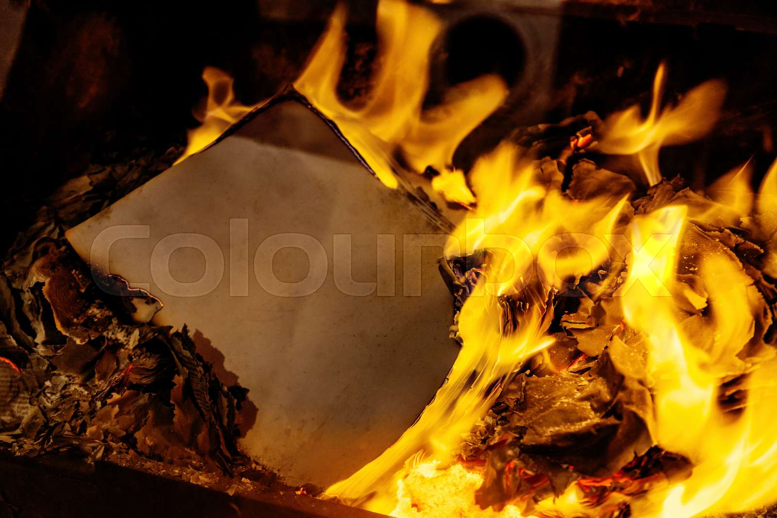 A sheet of paper on fire | Stock image | Colourbox