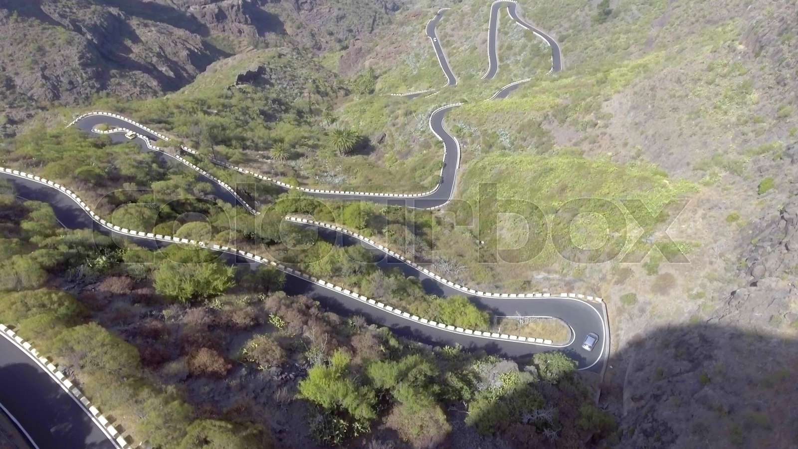 Overhead aerial view of a windy mountain road in summer season. | Stock ...