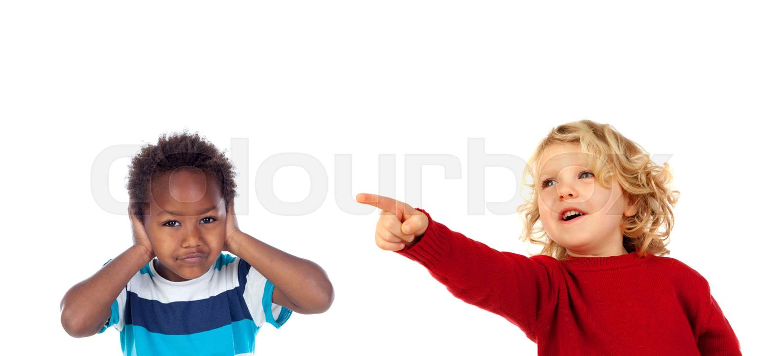 Blond child pointing at another one | Stock image | Colourbox