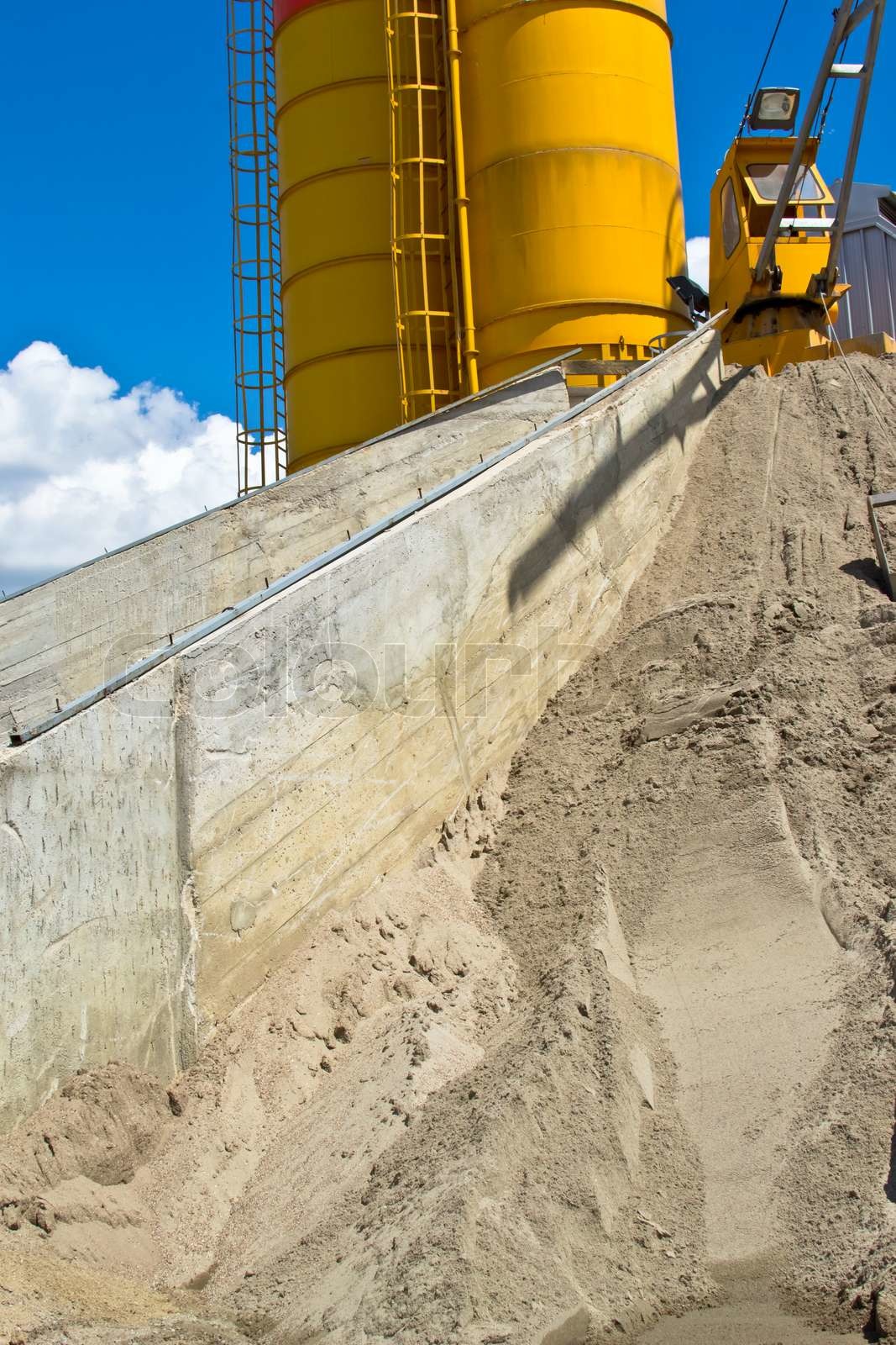 Heap of sand elimination with yellow silo | Stock image | Colourbox