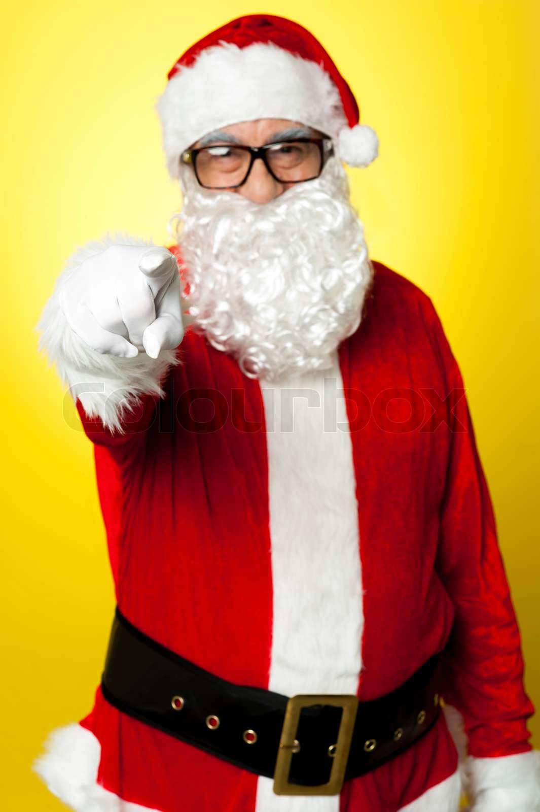 Jelly-belly Santa in spectacles pointing at you | Stock image | Colourbox