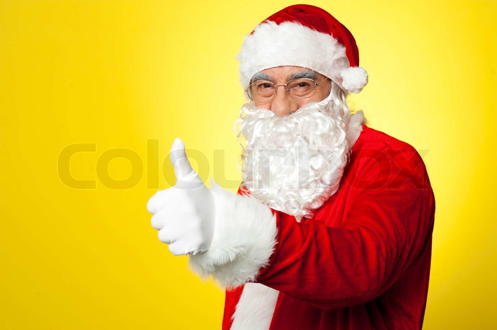 Santa showing thumbs up gesture to camera | Stock image | Colourbox