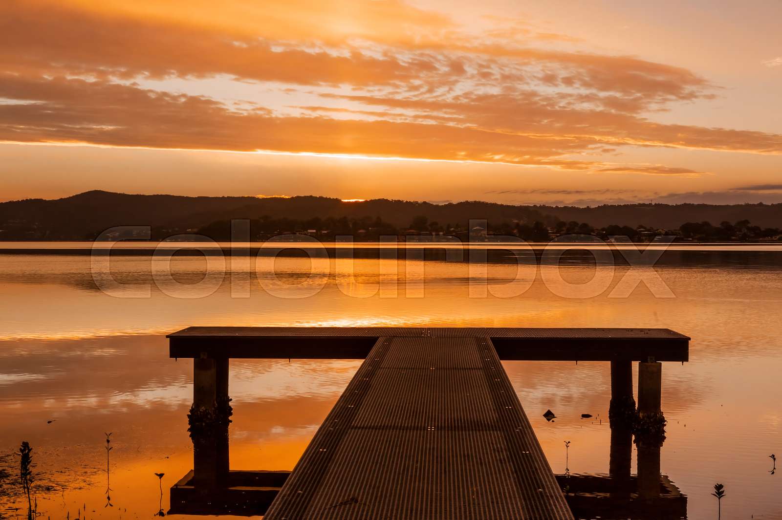 Sunset views from a small jetty on the lake | Stock image | Colourbox