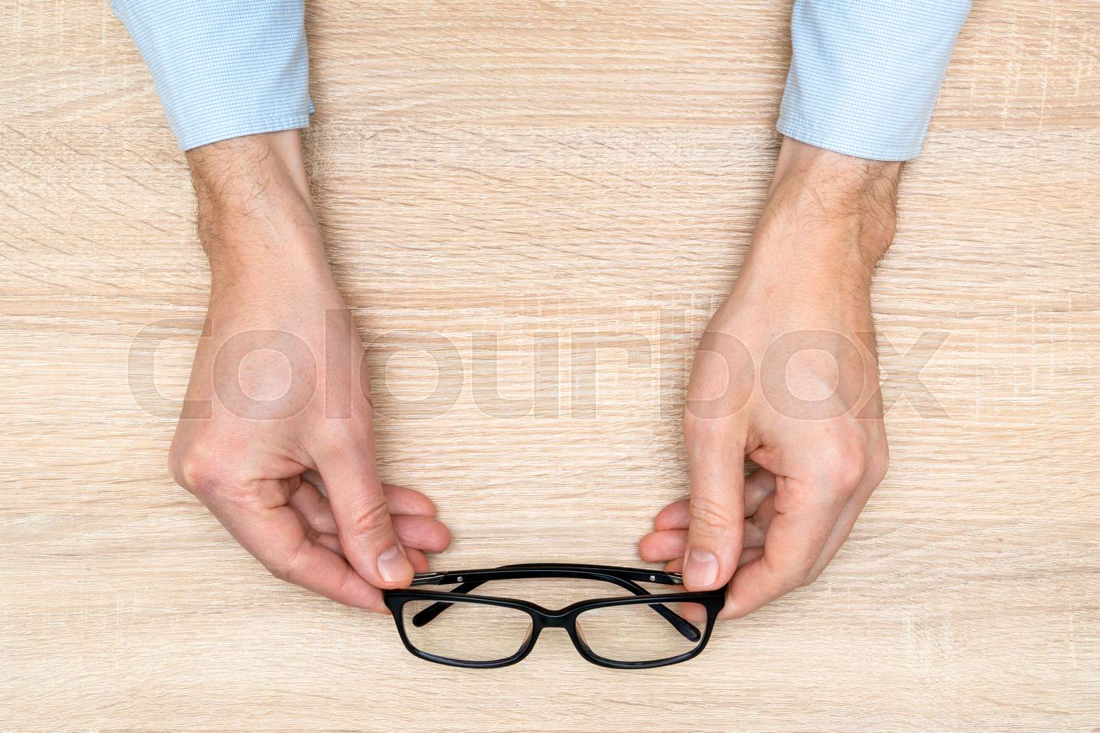 Hands holding eyeglasses | Stock image | Colourbox
