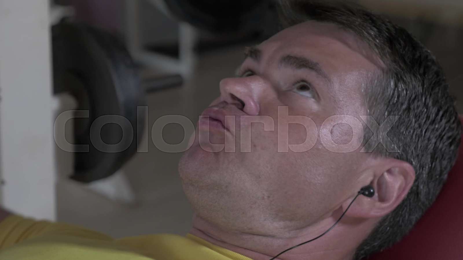 Young man working out hard with bench pressing | Stock video | Colourbox