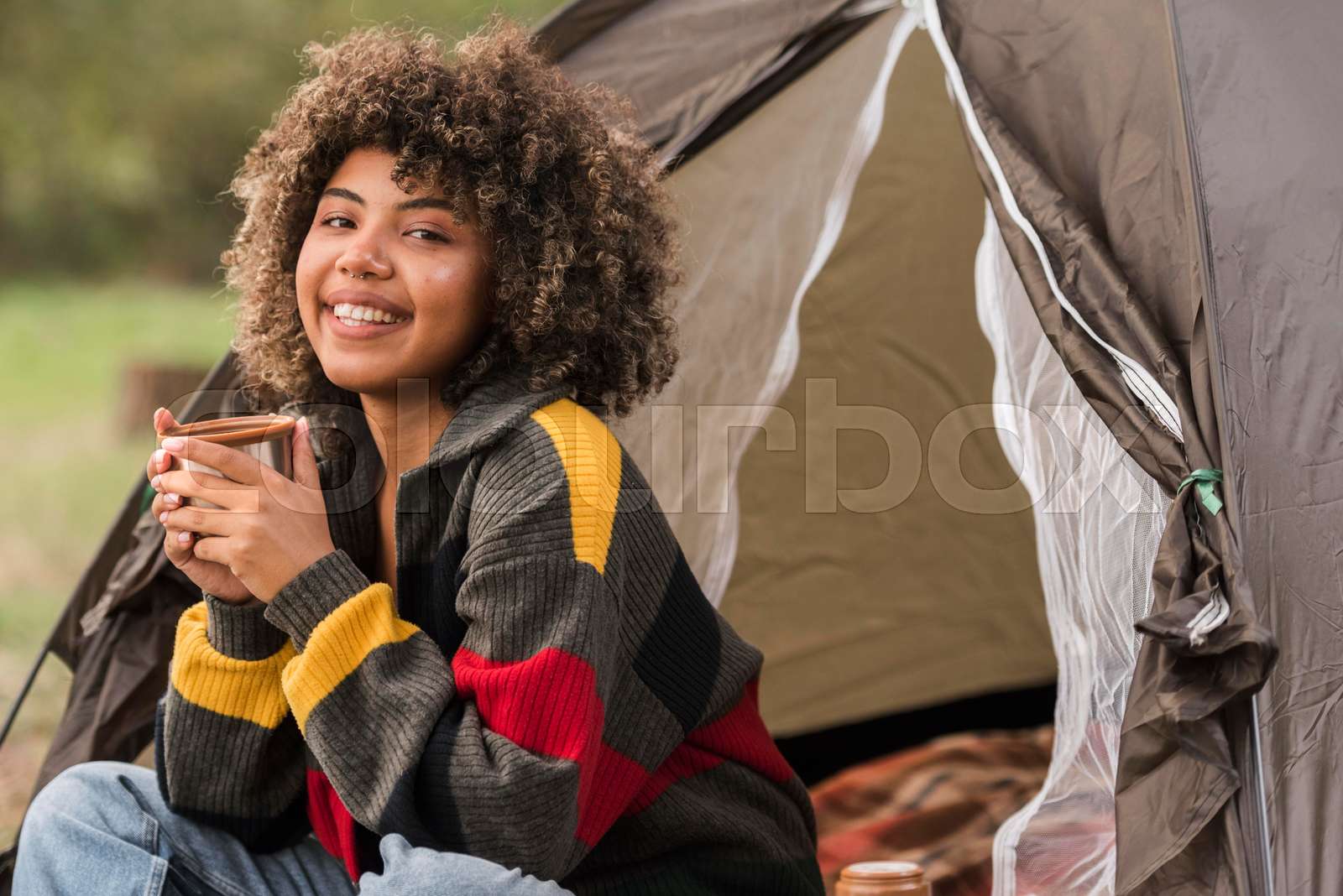 smiley woman camping outdoors with tent | Stock image | Colourbox