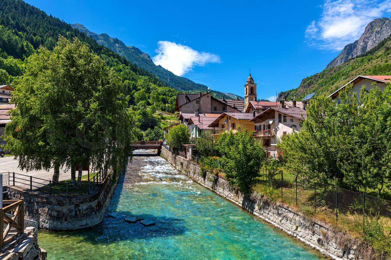 Alpine river and small town under blue sky in Piedmont, Italy. | Stock ...