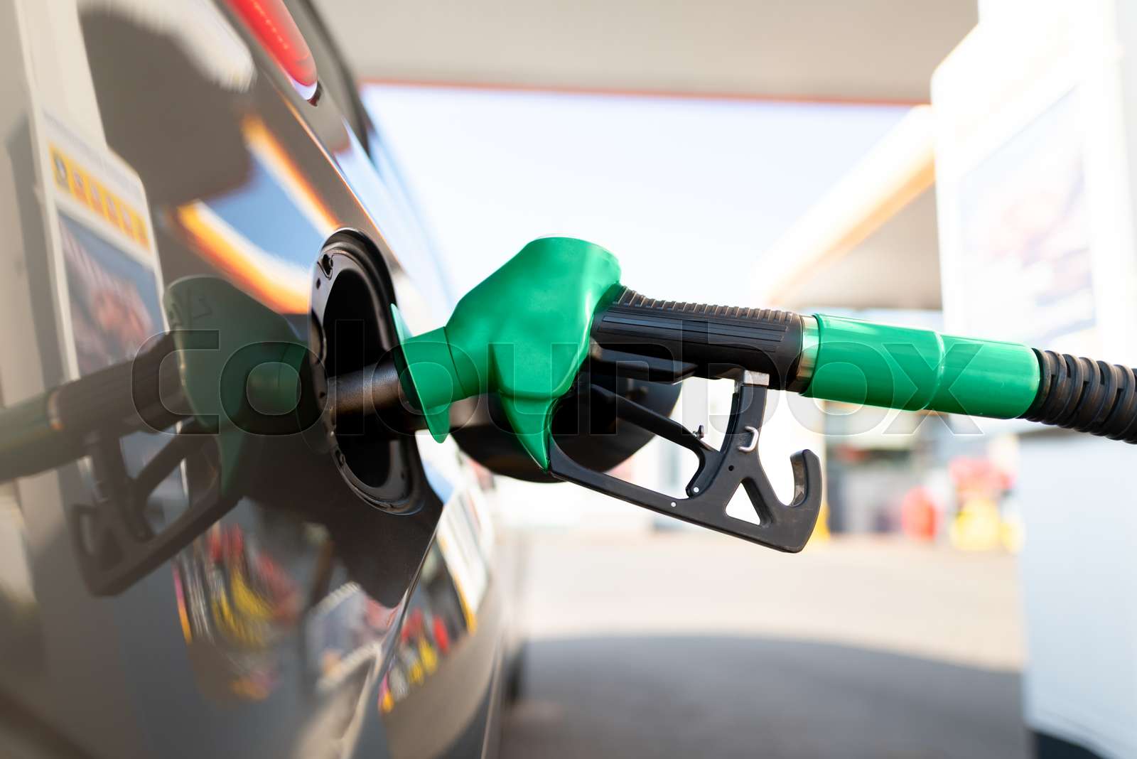 Vehicle fueling facility at petrol station | Stock image | Colourbox
