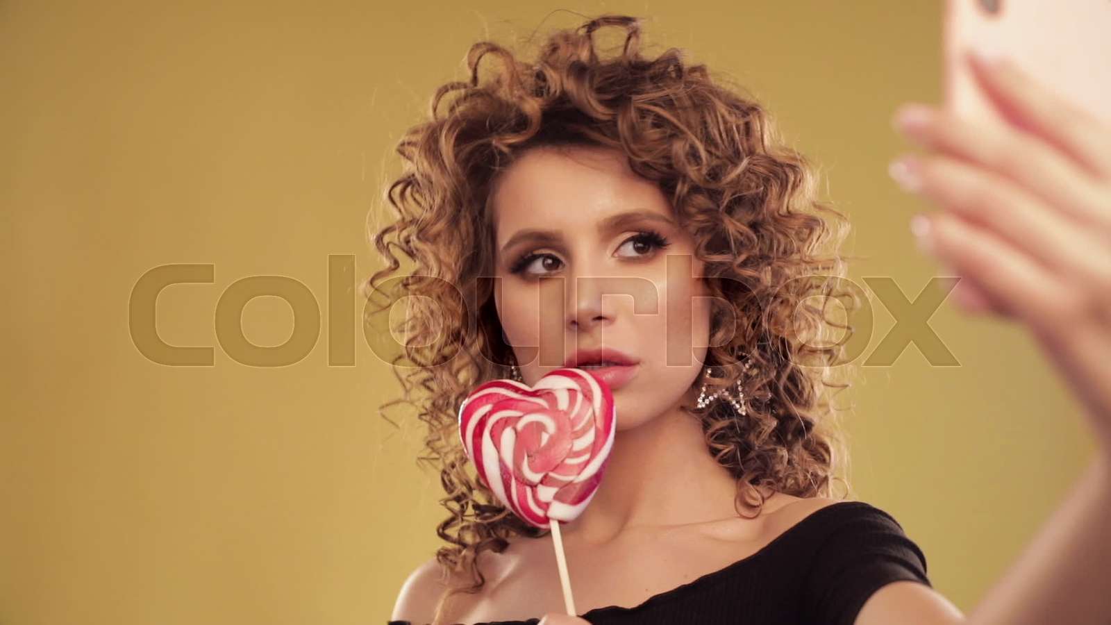 Woman taking selfie and posing on camera | Stock video | Colourbox