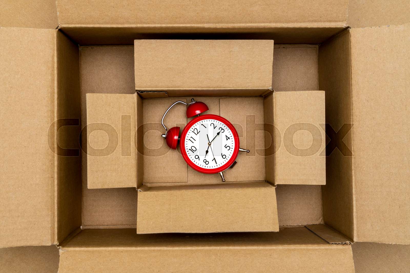 Retro red alarm clock in carton box | Stock image | Colourbox