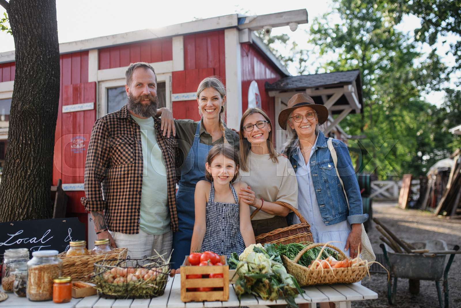 Family of farmers selling homegrown products at community farmers ...