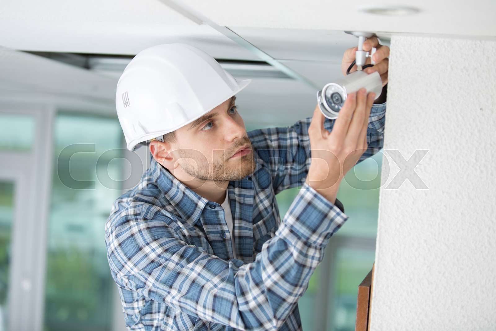 professional cctv technician working | Stock image | Colourbox