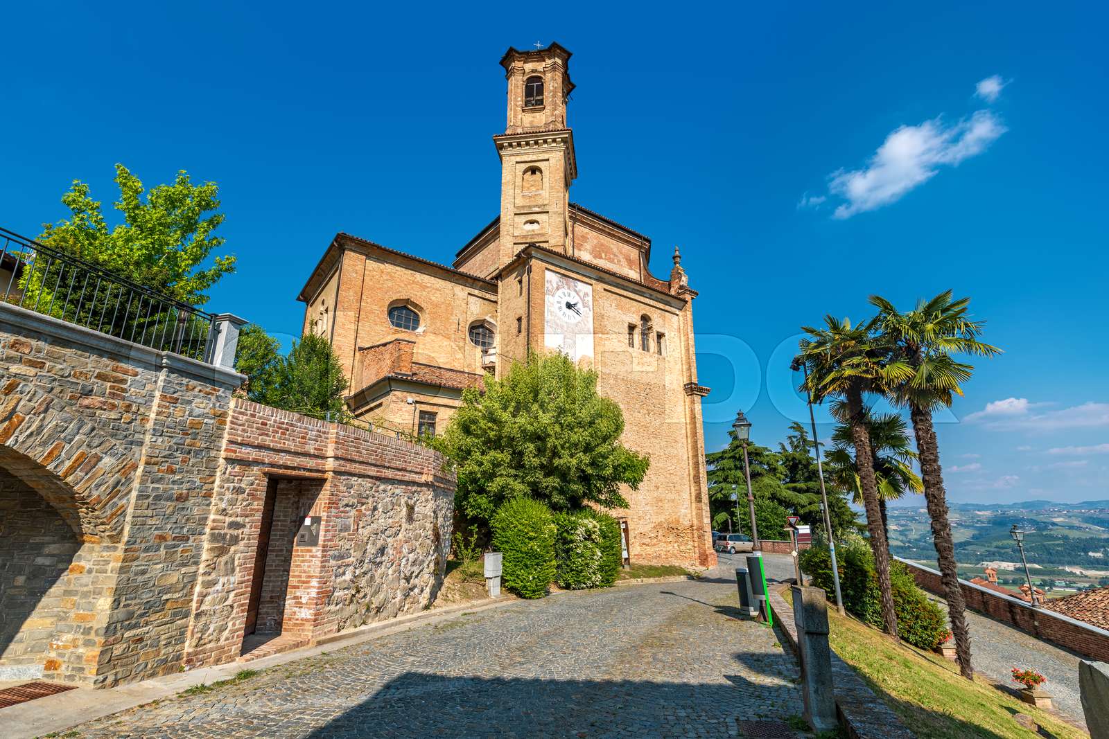 Cobblestone street and old church in Guarene, Italy. | Stock image ...