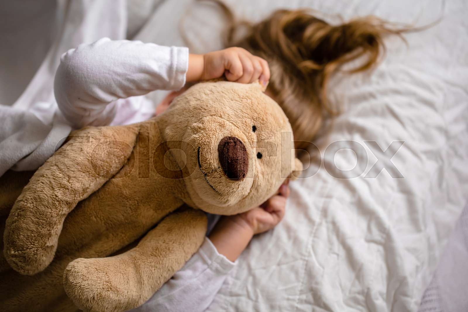 little girl in bed with soft toy the emotions of a child | Stock image ...
