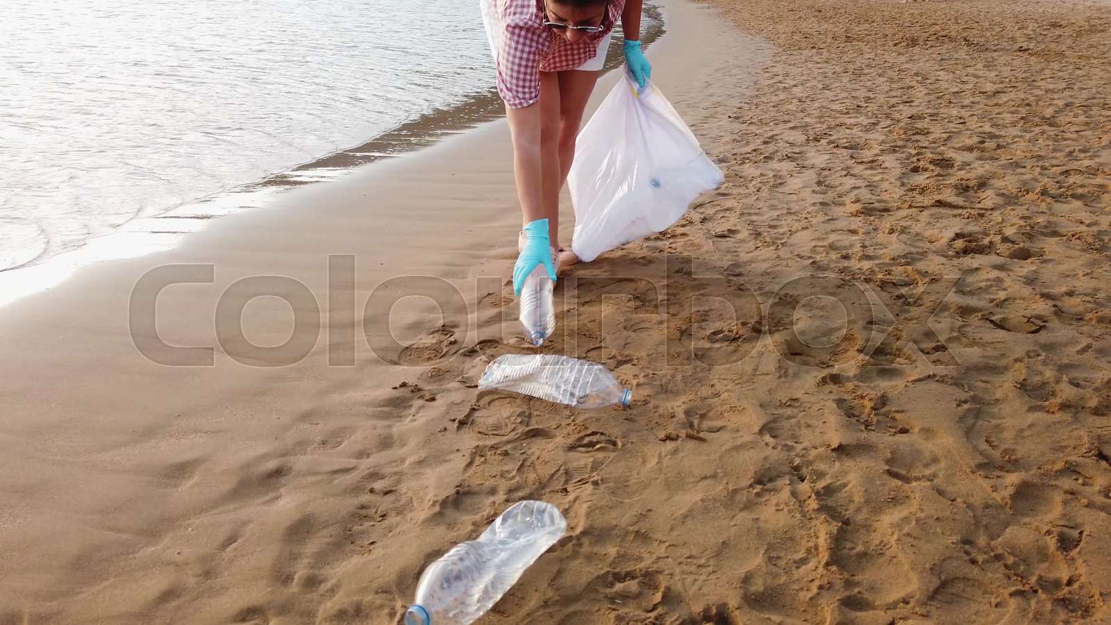cleaning plastic on the beach. | Stock video | Colourbox