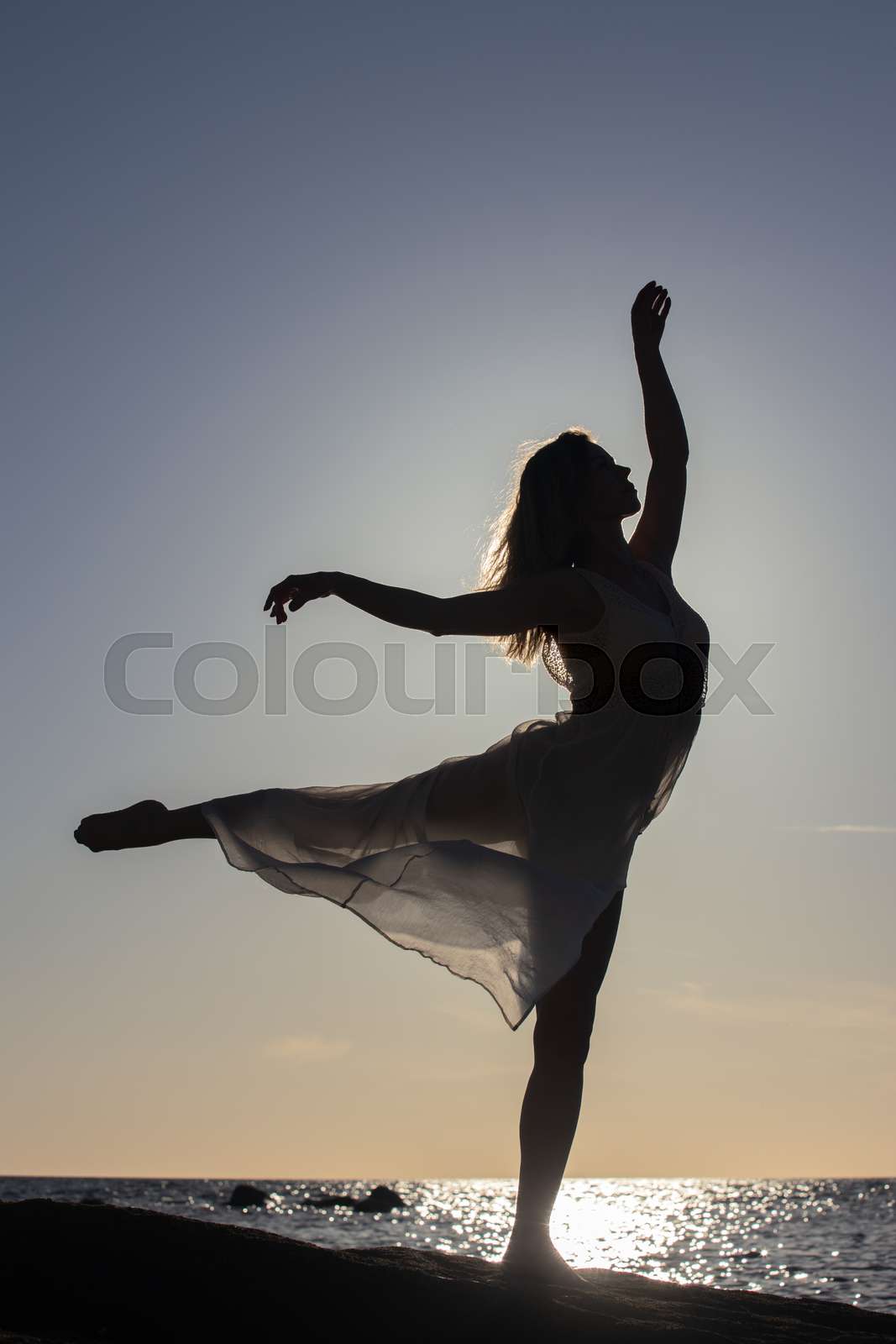 free happy woman silhouette at seaside | Stock image | Colourbox