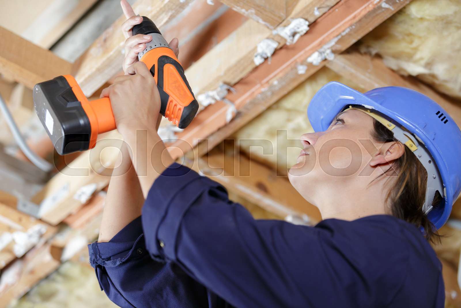 woman installing electrical outlet from the ceiling | Stock image ...