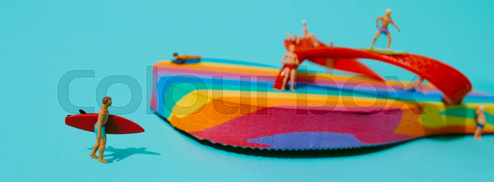 miniature men and rainbow flip-flop, banner | Stock image | Colourbox