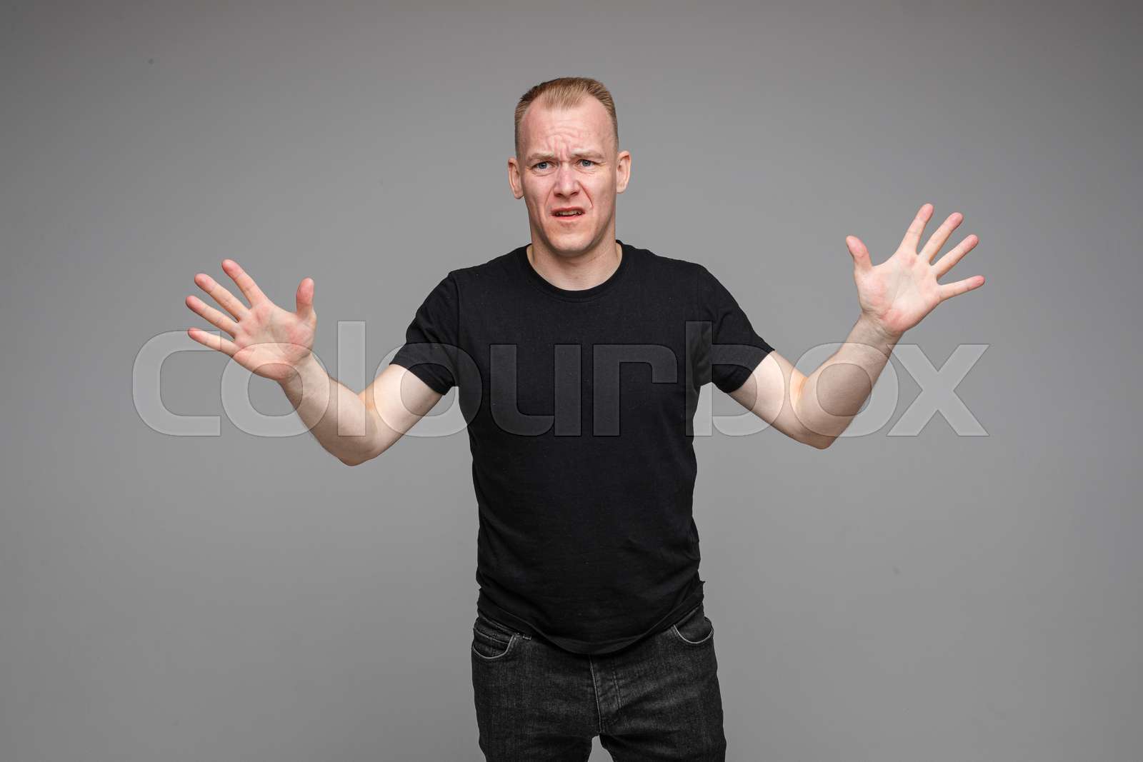 Stop it posing man with outstretched arms. | Stock image | Colourbox